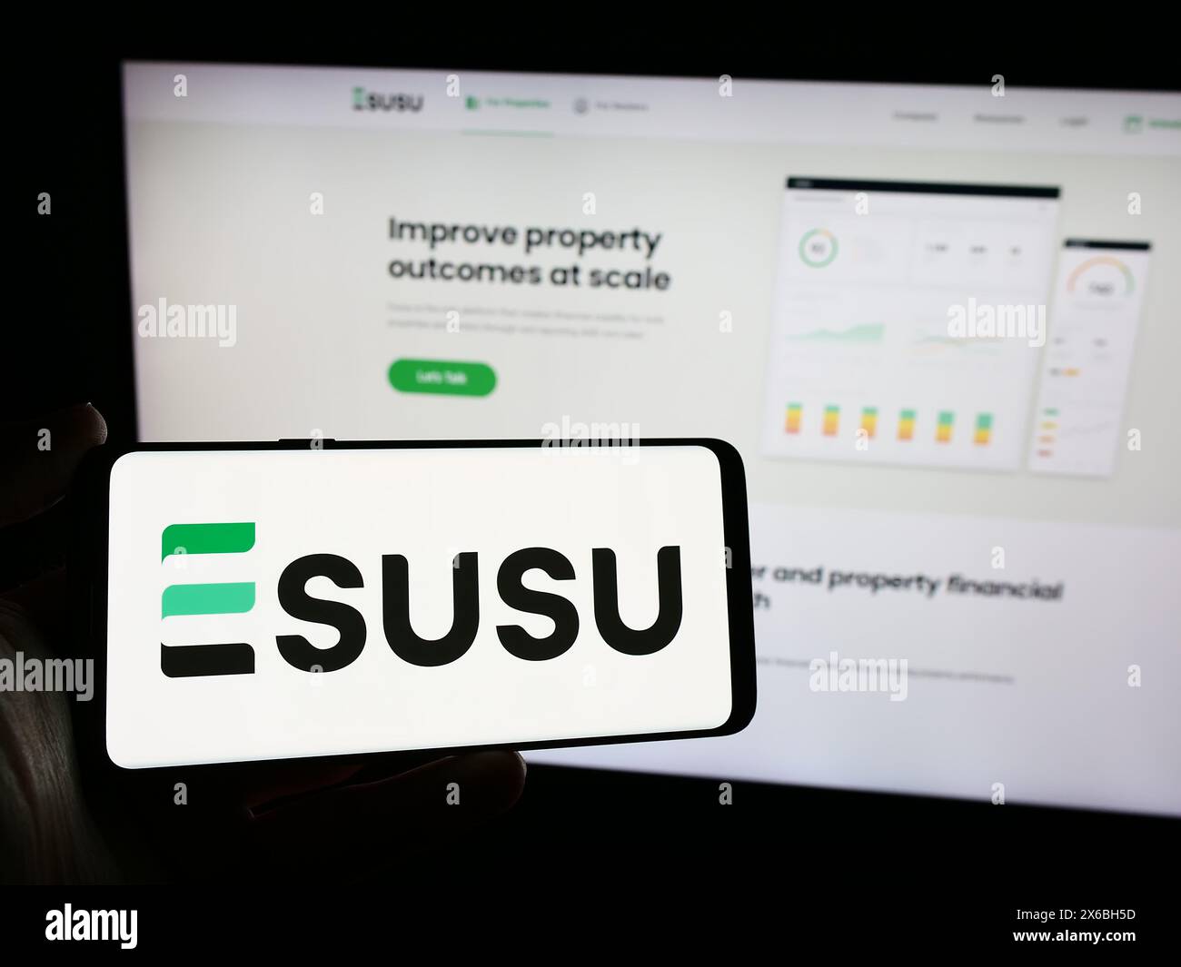 Person holding mobile phone with logo of American financial technology ...