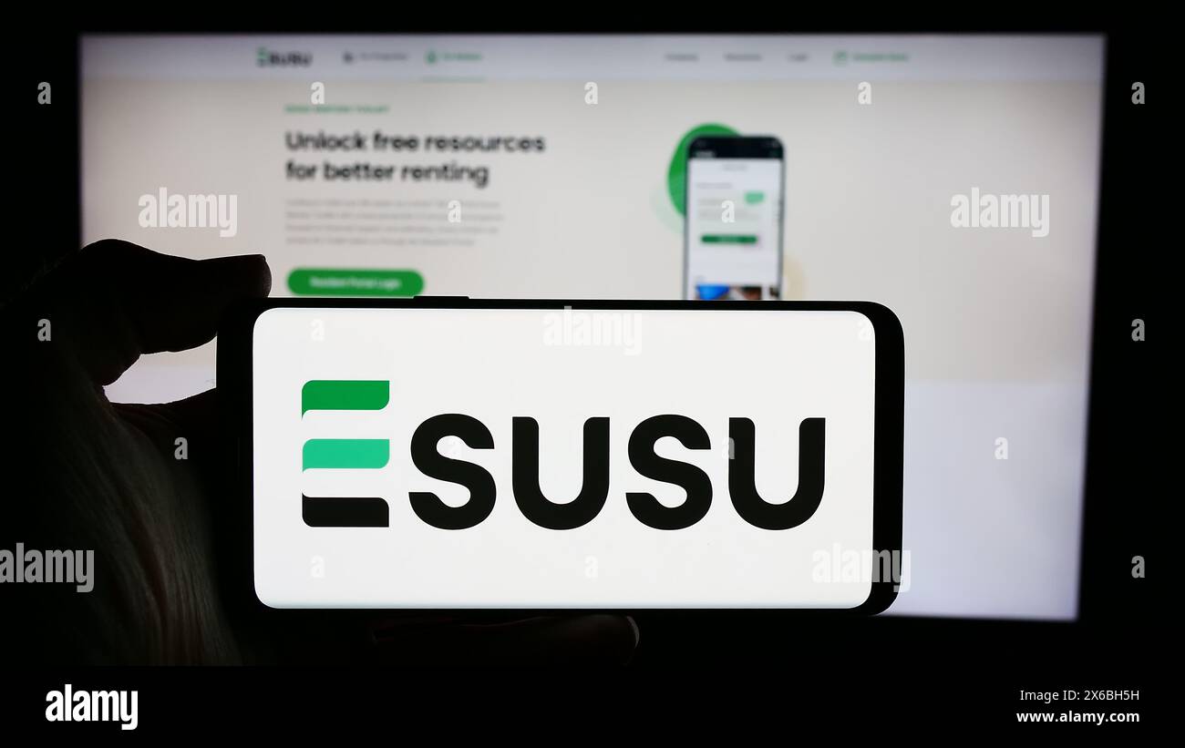 Person holding cellphone with logo of US financial technology company ...