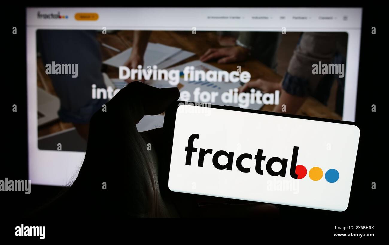 Person holding mobile phone with logo of artificial intelligence ...