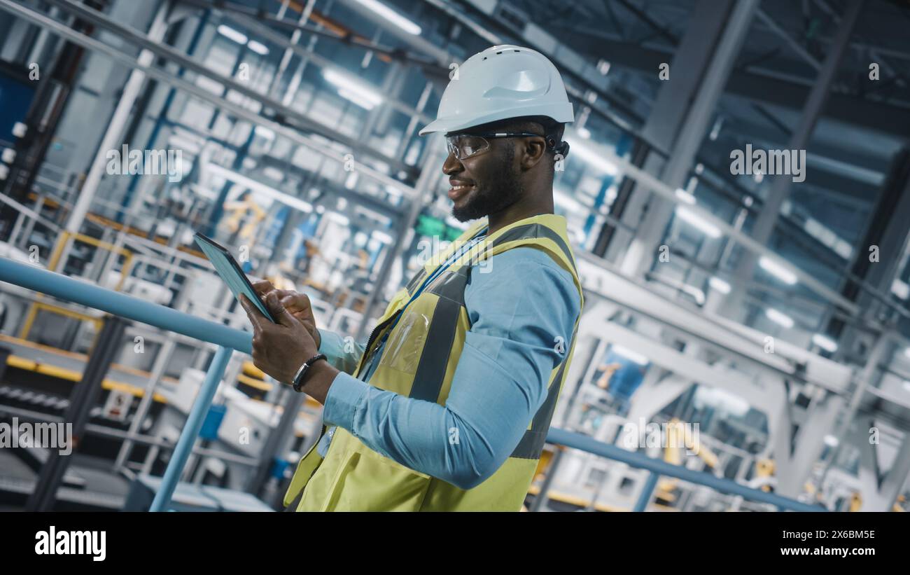 African American Car Factory Engineer in High Visibility Vest Use ...