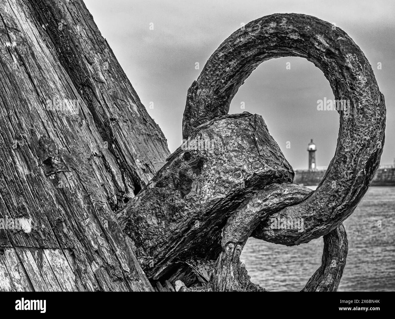 A close-up of an old rusting and disintegrating anchor ring and stock ...