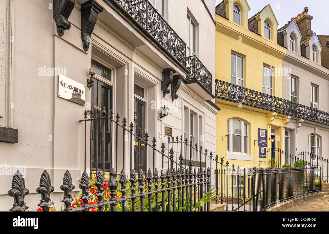 Well maintained seaside boarding houses with wrought iron railings and ...