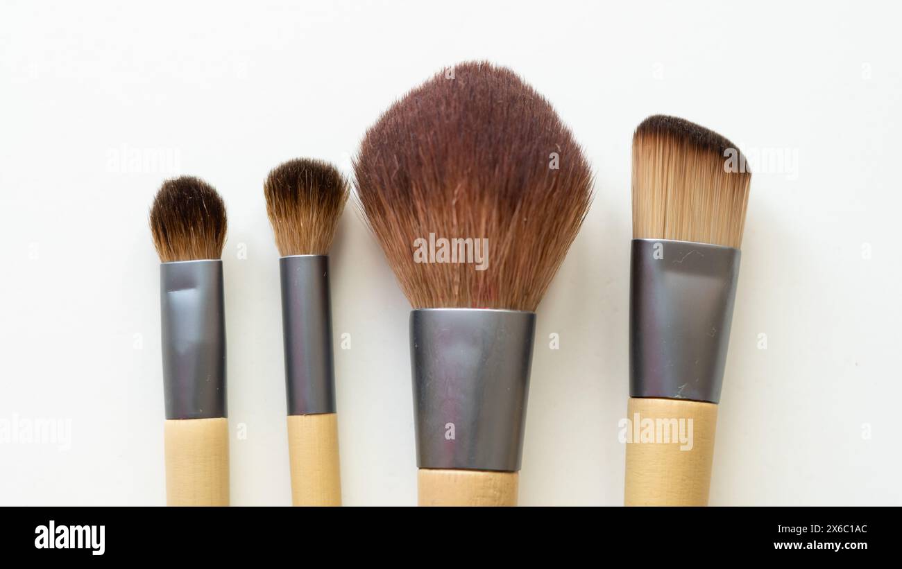 Wooden organic makeup brushes on white backdrop. Eco-friendly ...