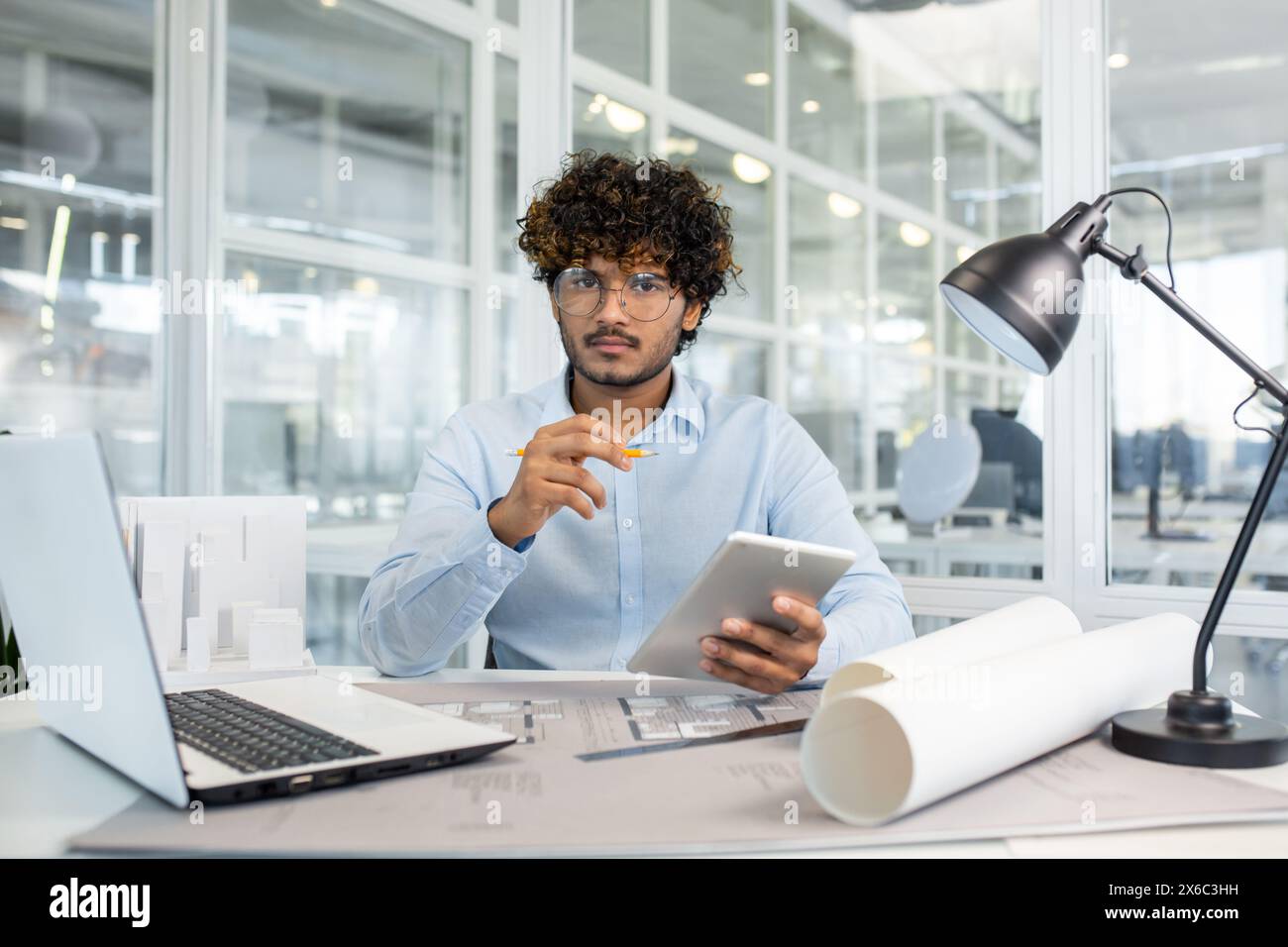 Architect working on a project in a modern office environment, using a ...