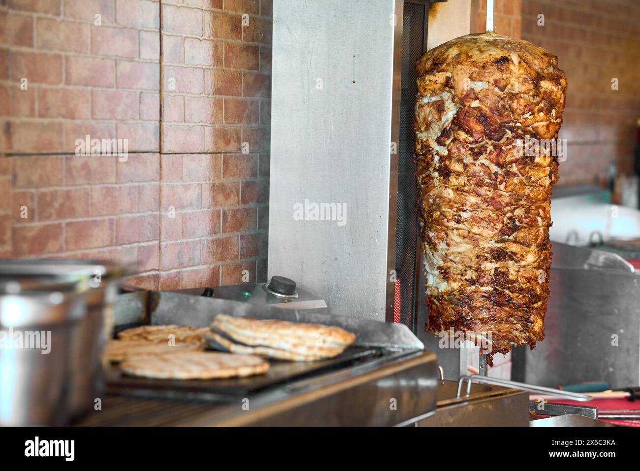 Santorini, Greece - 8 May 2024: A doner kebab meat skewer hanging from ...