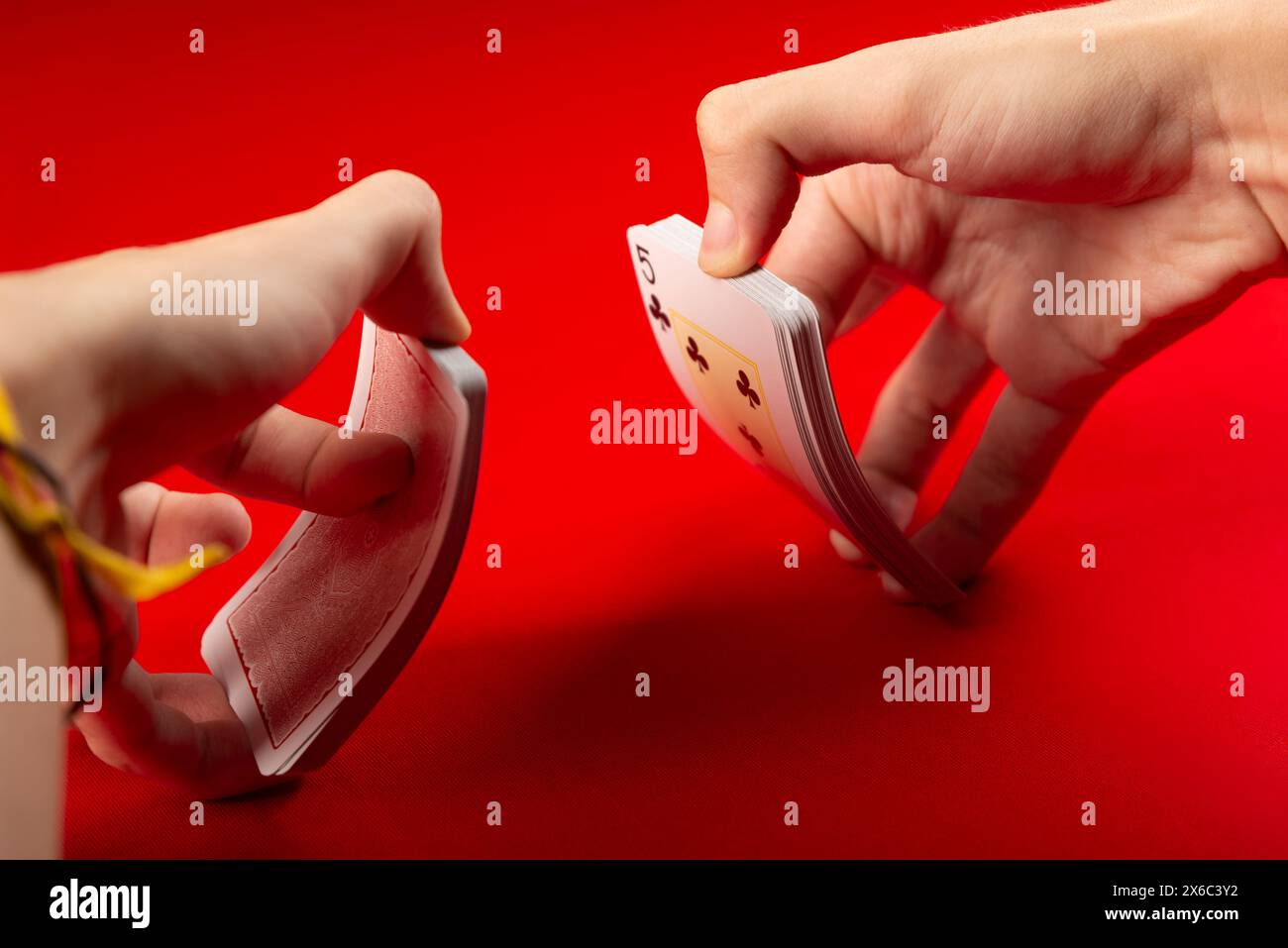 Male hand shuffling playing cards on the table. Board game. Isolated on ...