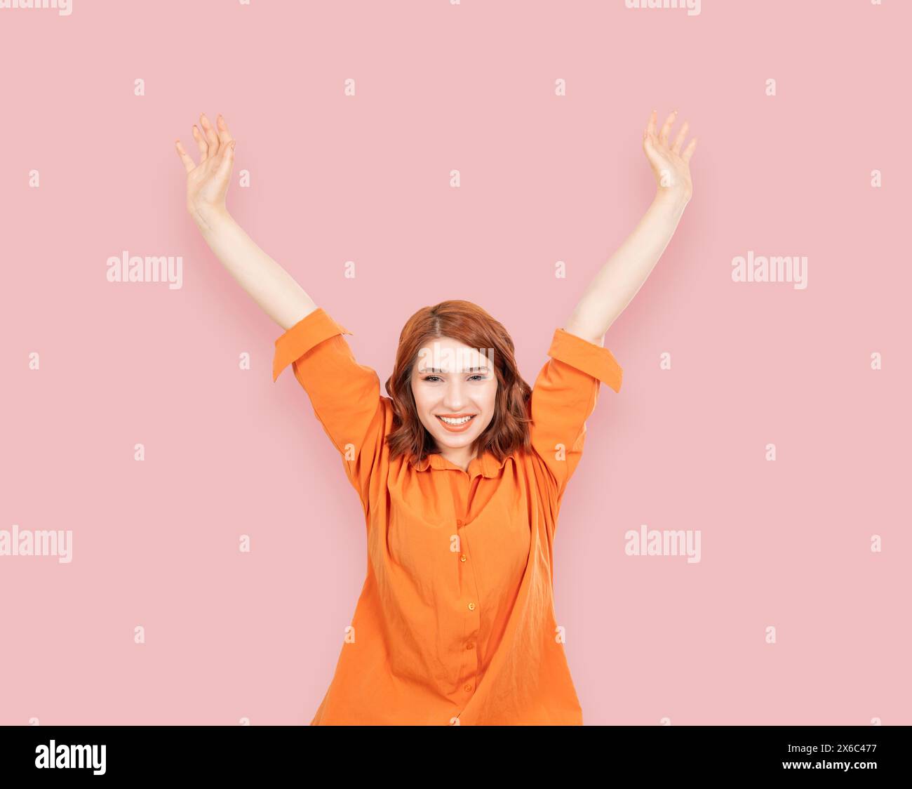 Portrait of young red bob hair caucasian happy woman arms raised up ...