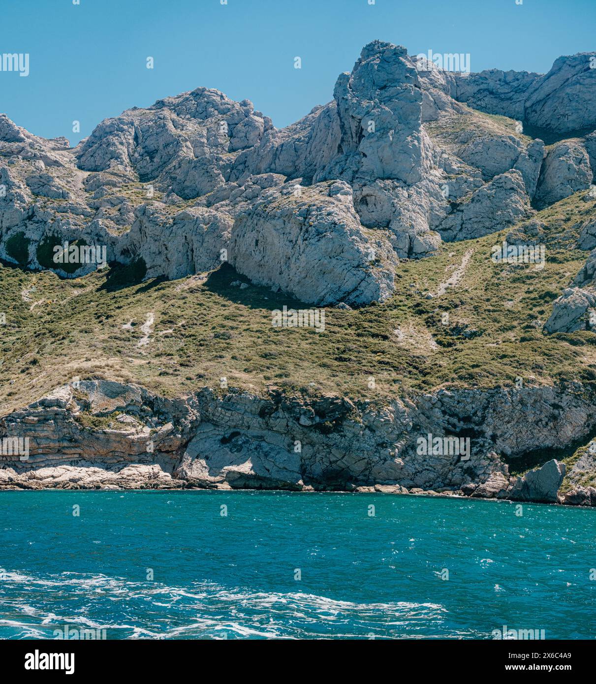 Steep rocky cliffs above a serene sea in The Calanques, Marseille Stock ...