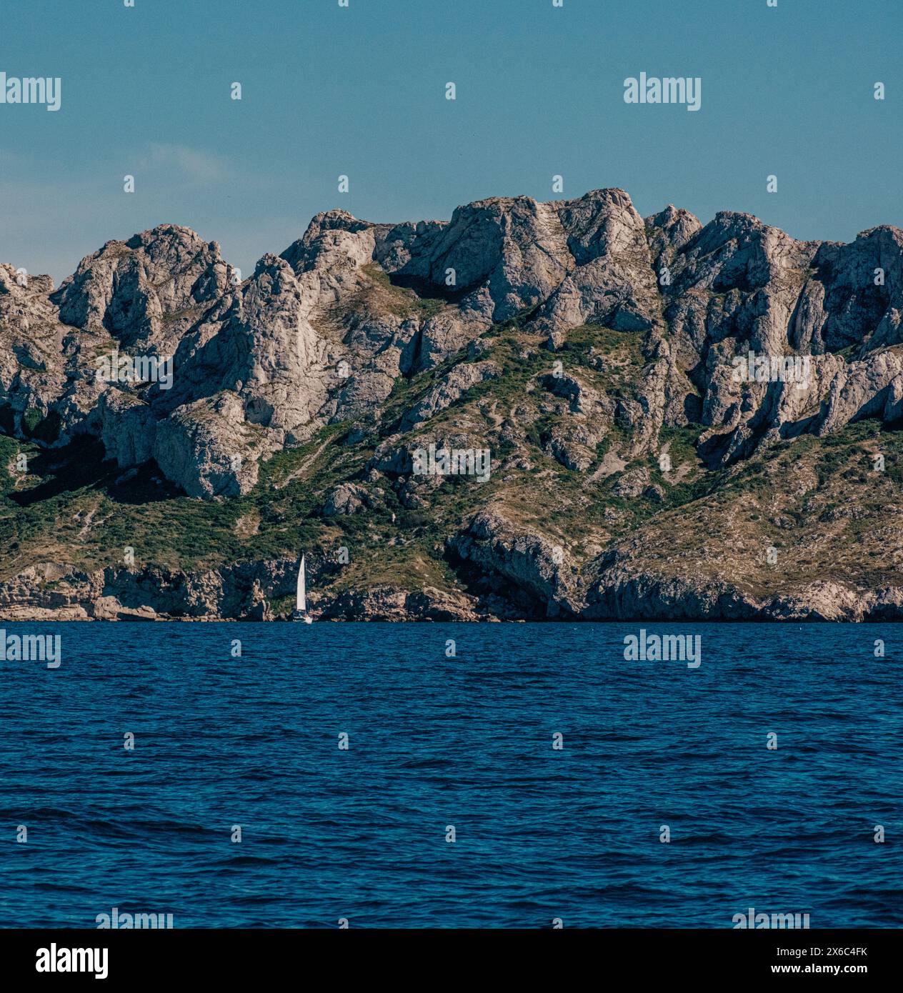 Steep rocky cliffs above a serene sea in The Calanques, Marseille Stock ...