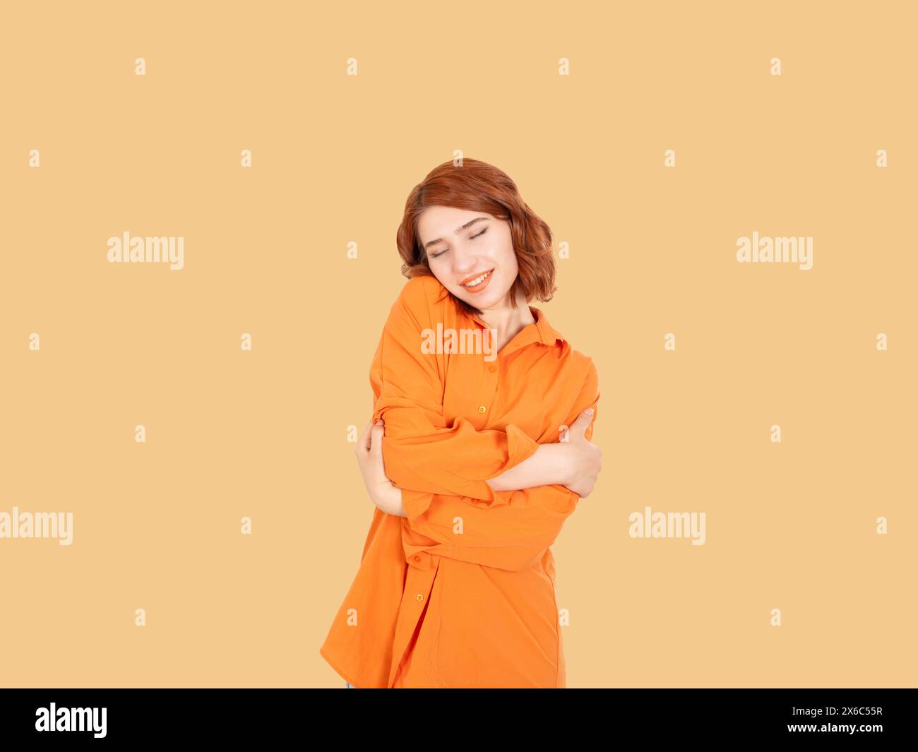 Hugging self, full of love pretty caucasian young woman hugging self ...