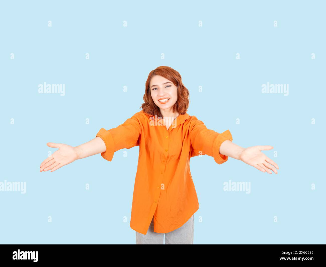 Woman give a warm welcome, spreading her arms wide open to hug you ...