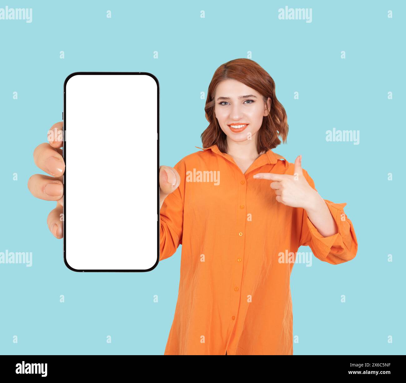 portrait of young red hair caucasian girl holding showing empty blank ...