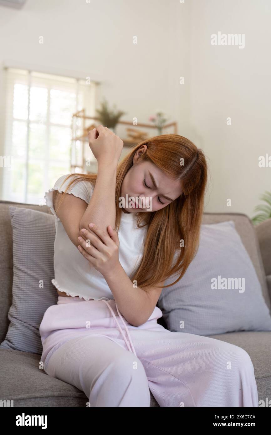 Asian woman have elbow pain, inflammation of tendon or ligament injury ...