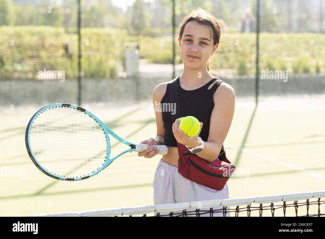 A person holding a racket on a court Stock Photo - Alamy