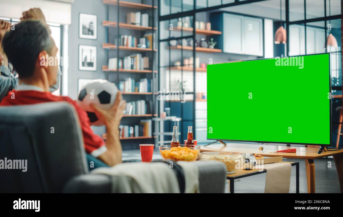 At Home Joyful Soccer Fans Sit on a Couch Watch Green Screen Chroma Key ...