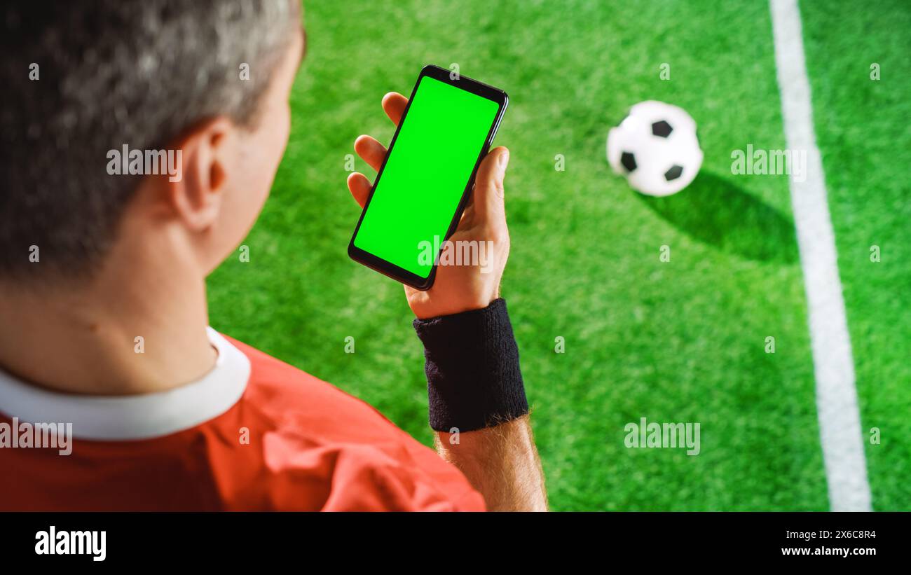 Professional Soccer Player Holding Smartphone with Green Screen Chroma ...