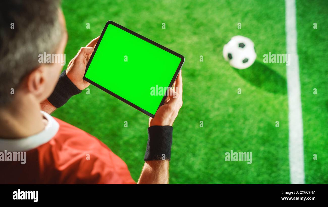 Professional Soccer Player Holding Digital Tablet Computer with Green ...