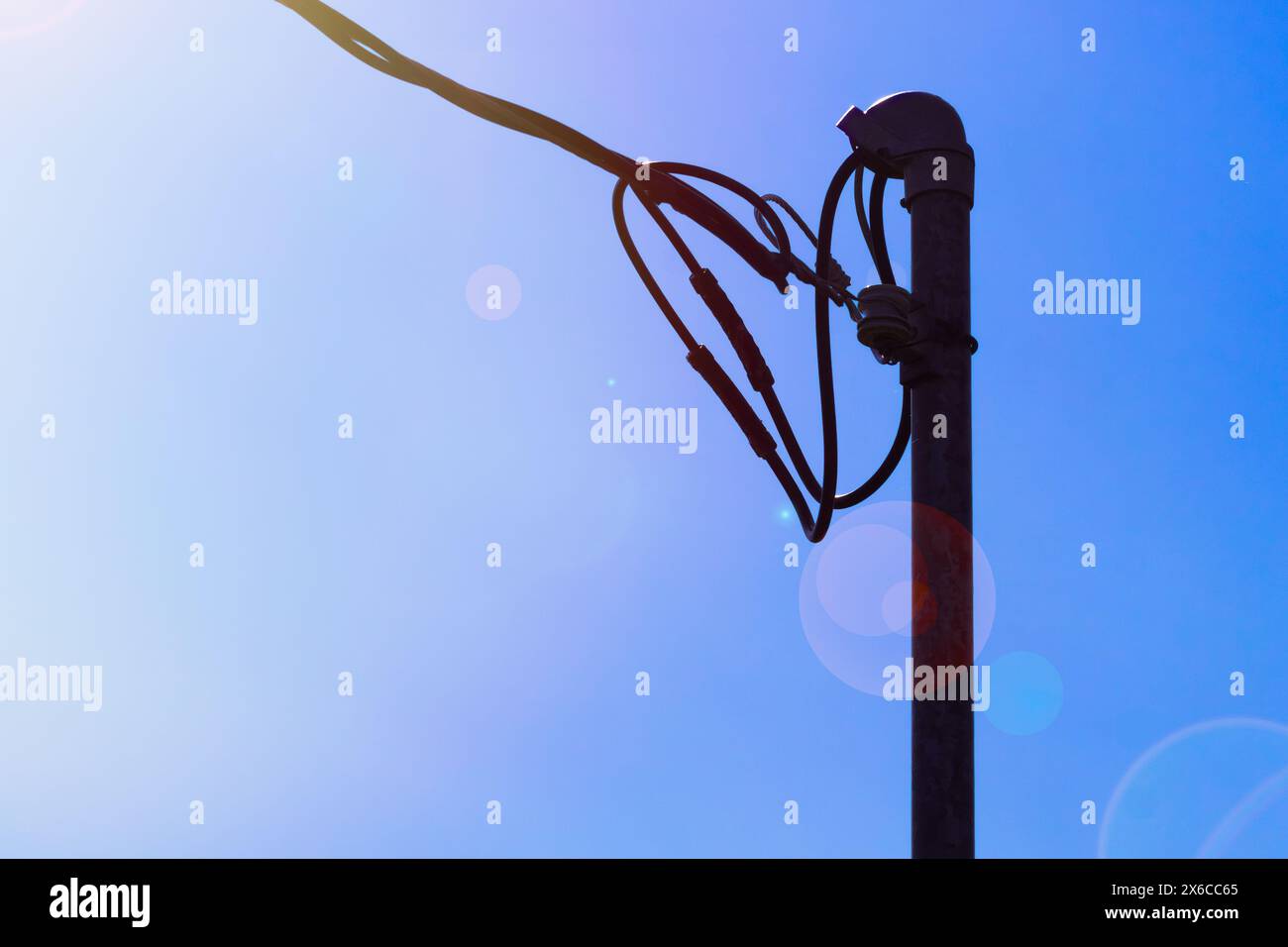 Electrical power mast and sun flare Stock Photo - Alamy