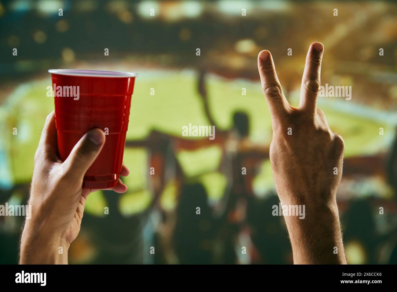 Sport fans raising hands to support favorite football team. Gathering ...