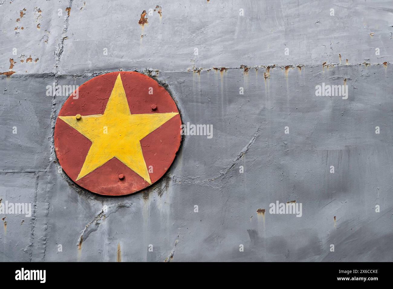 Symbol of the Vietnamese flag, red with a yellow star, against a gun ...