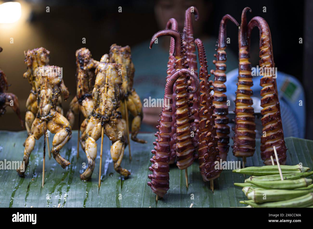 Street food in a Vietnamese market - whole frogs and octopus tentacles ...