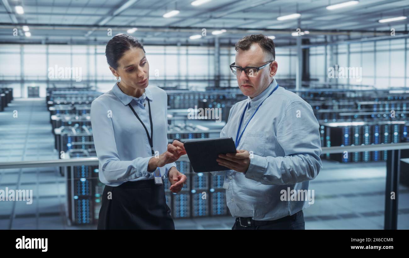 Data Center Female System Administrator and Male IT Specialist Talk ...