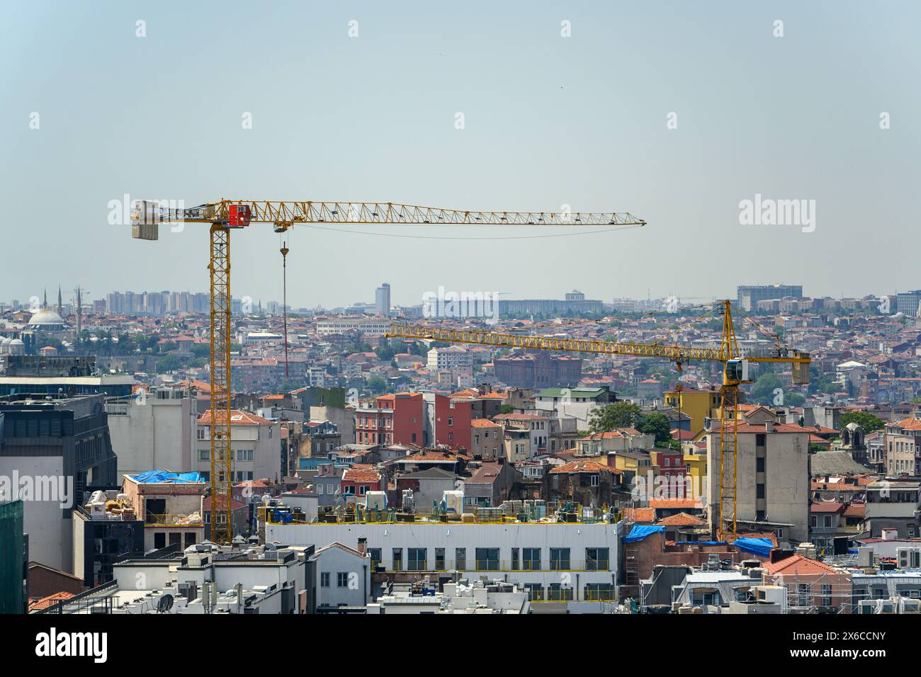 Construction crane working on large construction site Stock Photo - Alamy