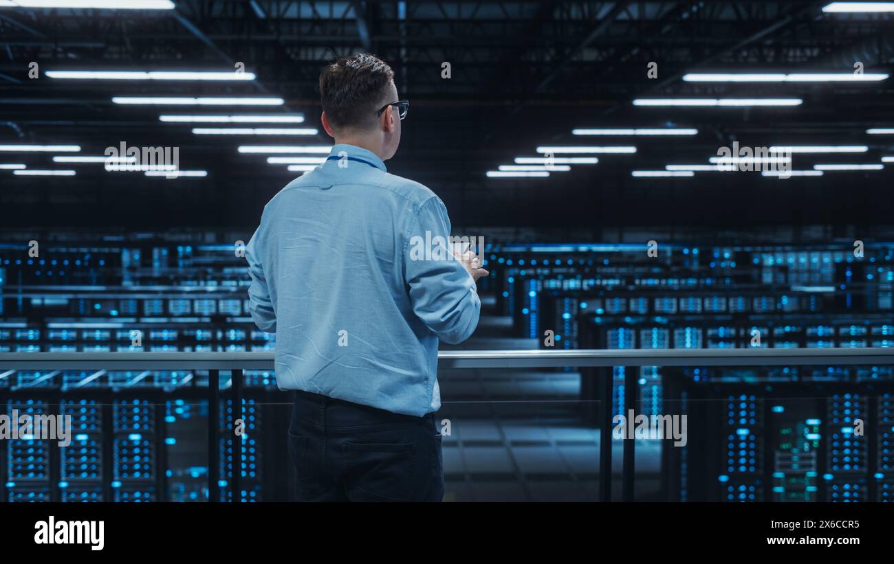 Data Center Engineer Using Laptop Computer. Server Farm Cloud Computing ...