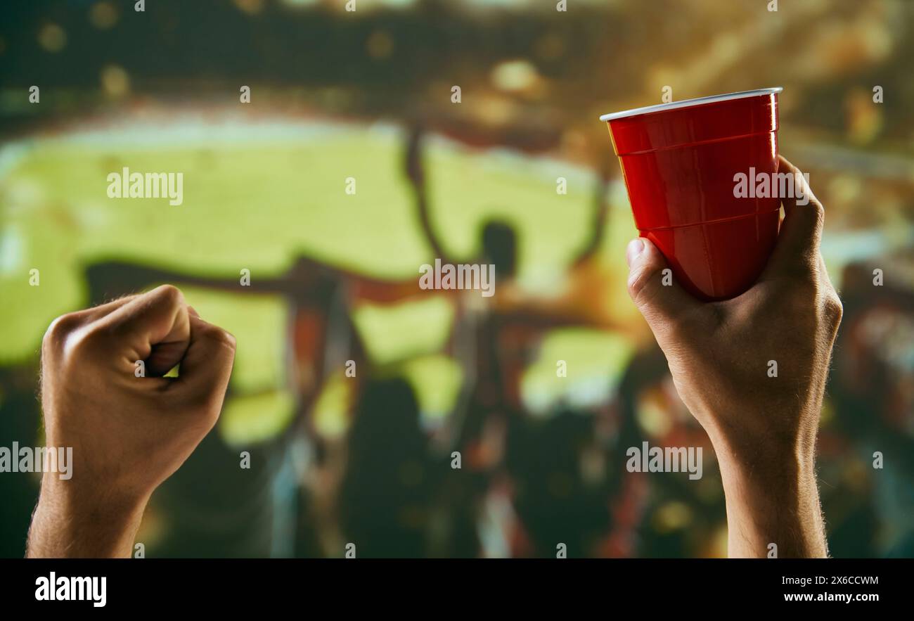 Sport fans raising hands to support favorite football team. Gathering ...