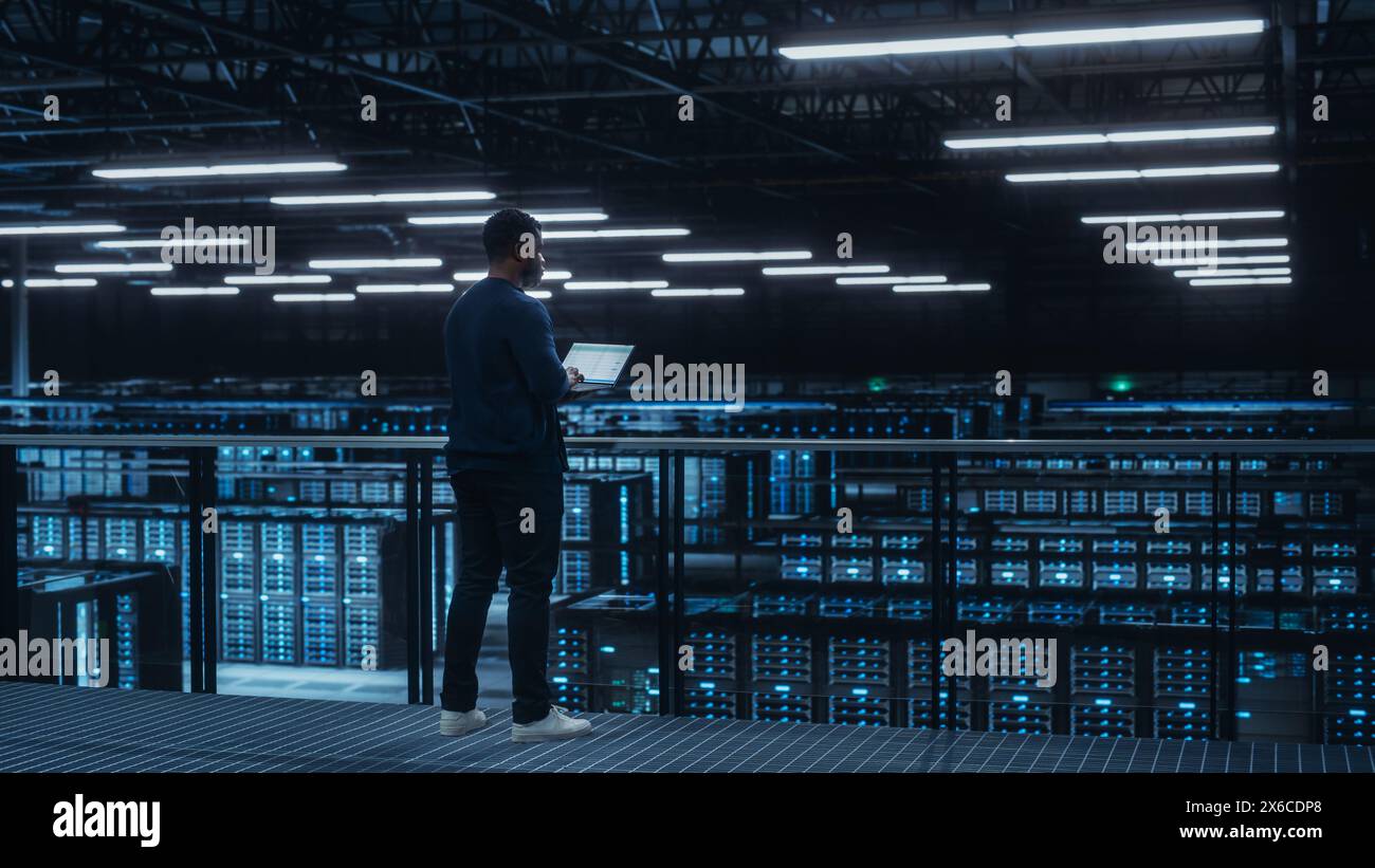 Data Center Engineer Using Laptop Computer. Server Farm Cloud Computing ...