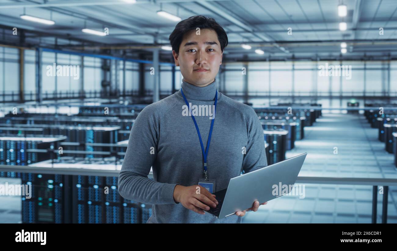 Portrait of a Data Center Engineer Using Laptop Computer. Server Room ...