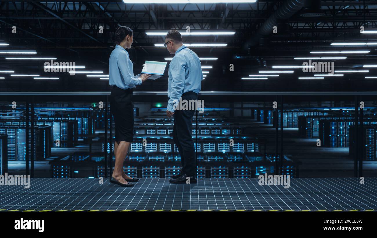 Data Center Female System Administrator and Male IT Specialist Talk ...