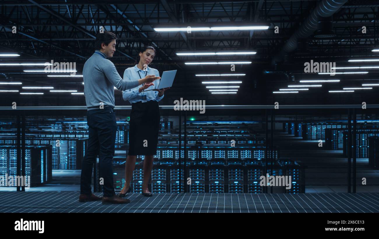 Data Center Female System Administrator and Male IT Specialist Talk ...