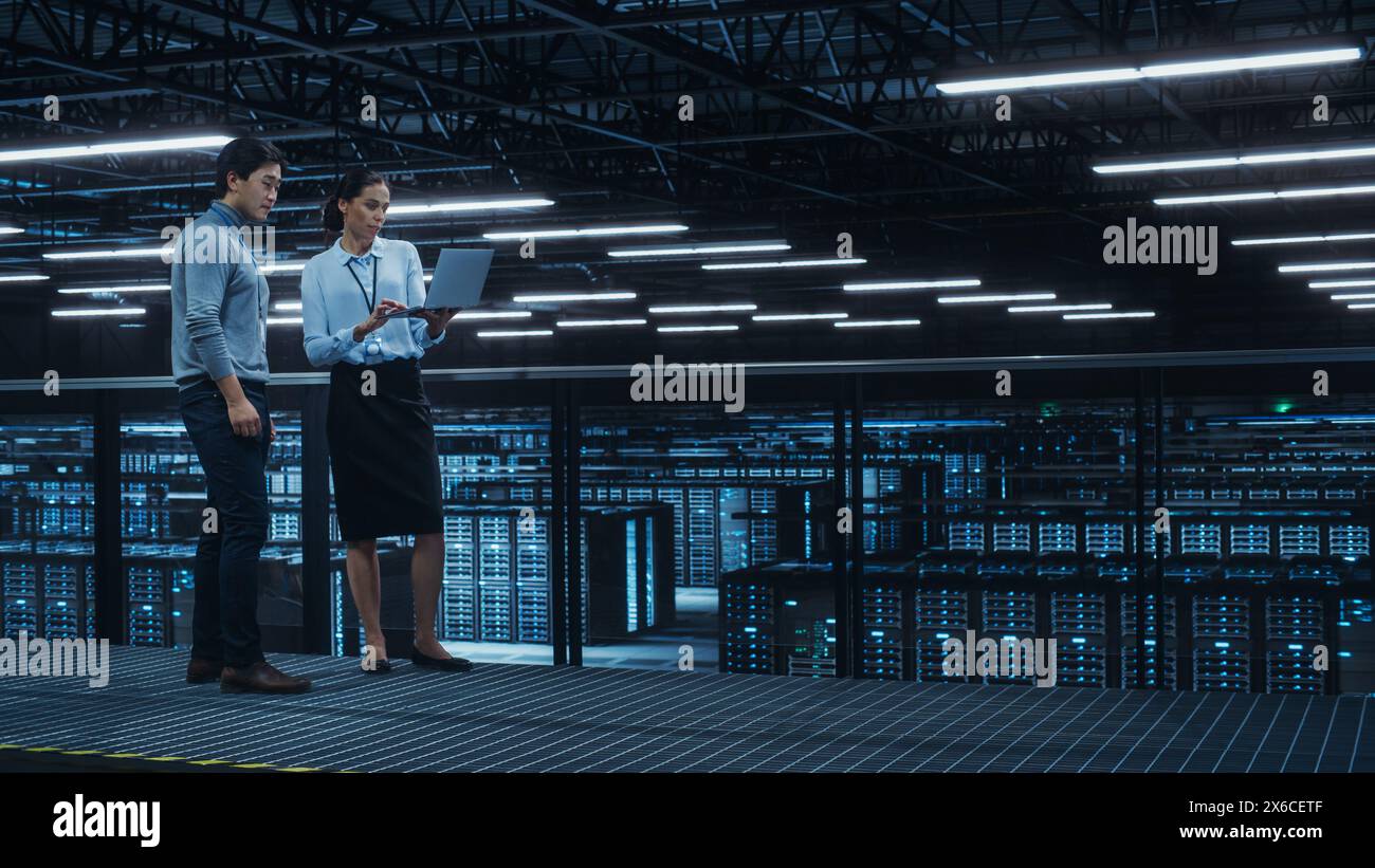 Data Center Female System Administrator and Male IT Specialist Talk ...