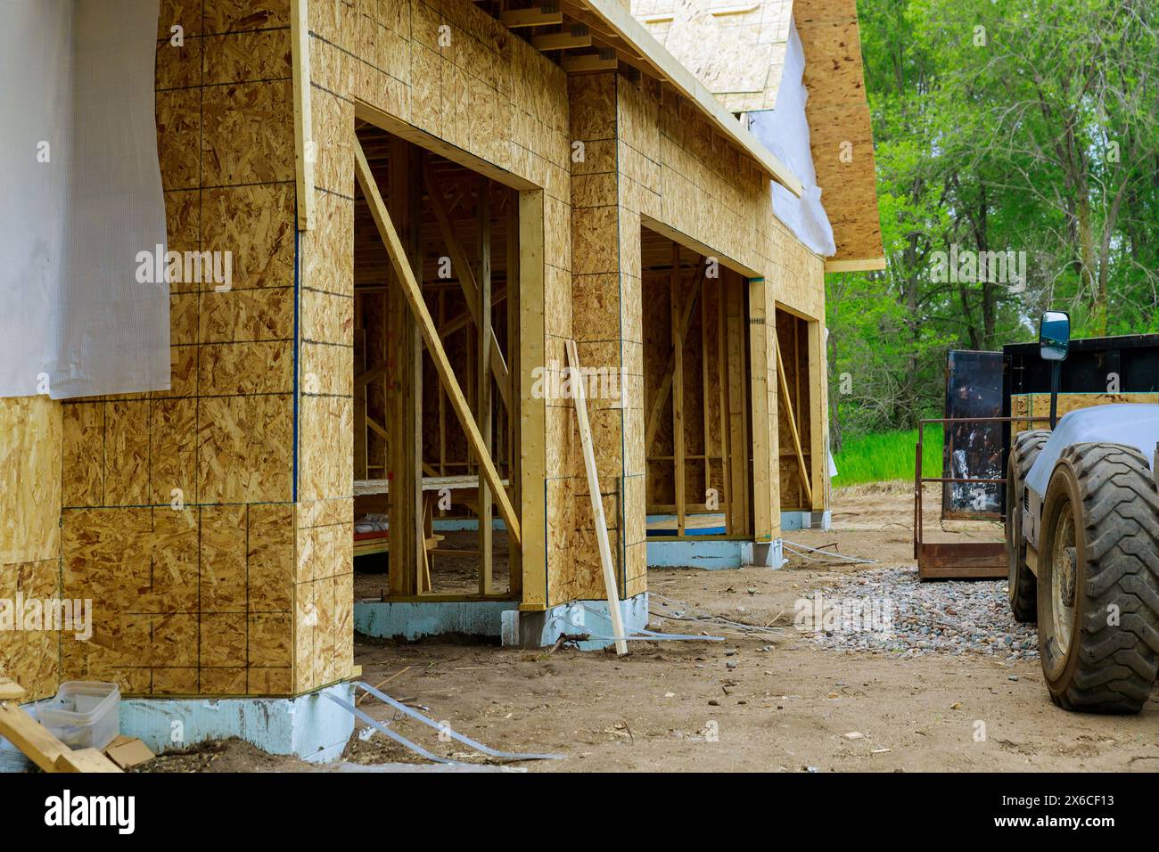 Currently, joist framework for house is being installed, along with ...