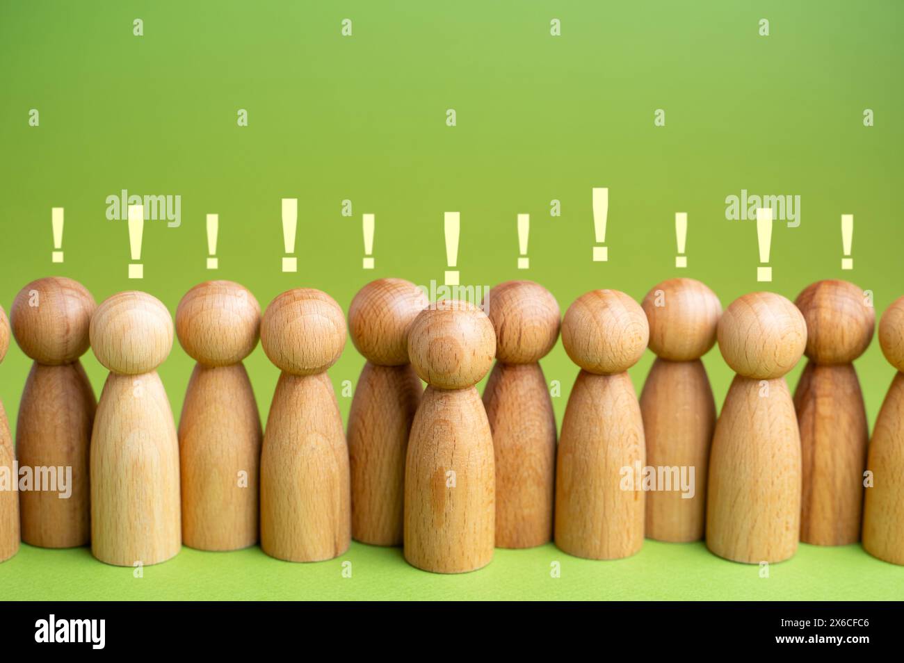 A crowd of people and exclamation signs overhead. Stress and exhaustion ...