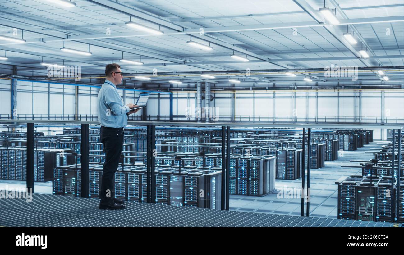 Data Center Engineer Using Laptop Computer. Server Farm Cloud Computing ...