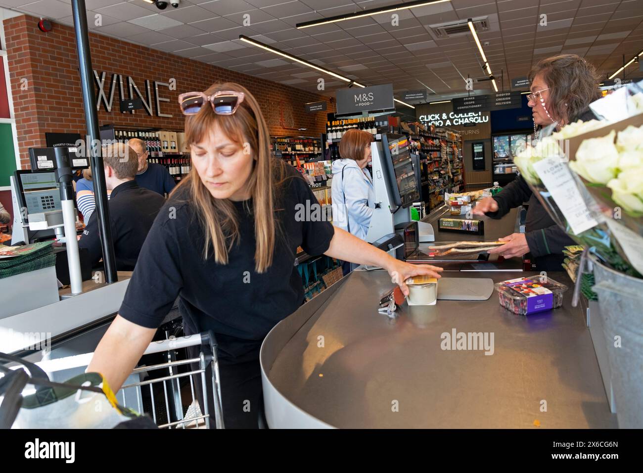 Young woman shopper packing up shopping groceries Marks and Spencer ...