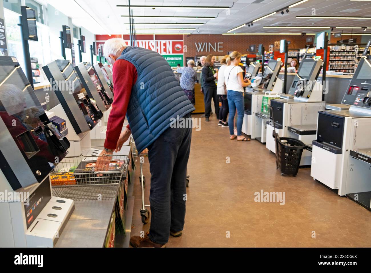 People customers shoppers elderly older man rear back view using self ...