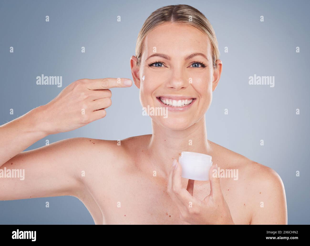 Woman, face cream and jar in portrait by studio with application ...