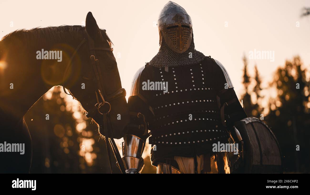 Medieval Knight Leading His Horse into the Battle to Fight. Warrior in Armor, Helmet, Sword and ...