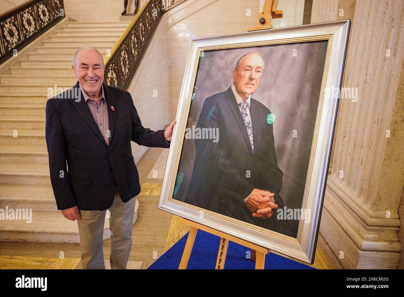 Former Stormont Assembly speaker Mitchel McLaughlin stands beside a ...