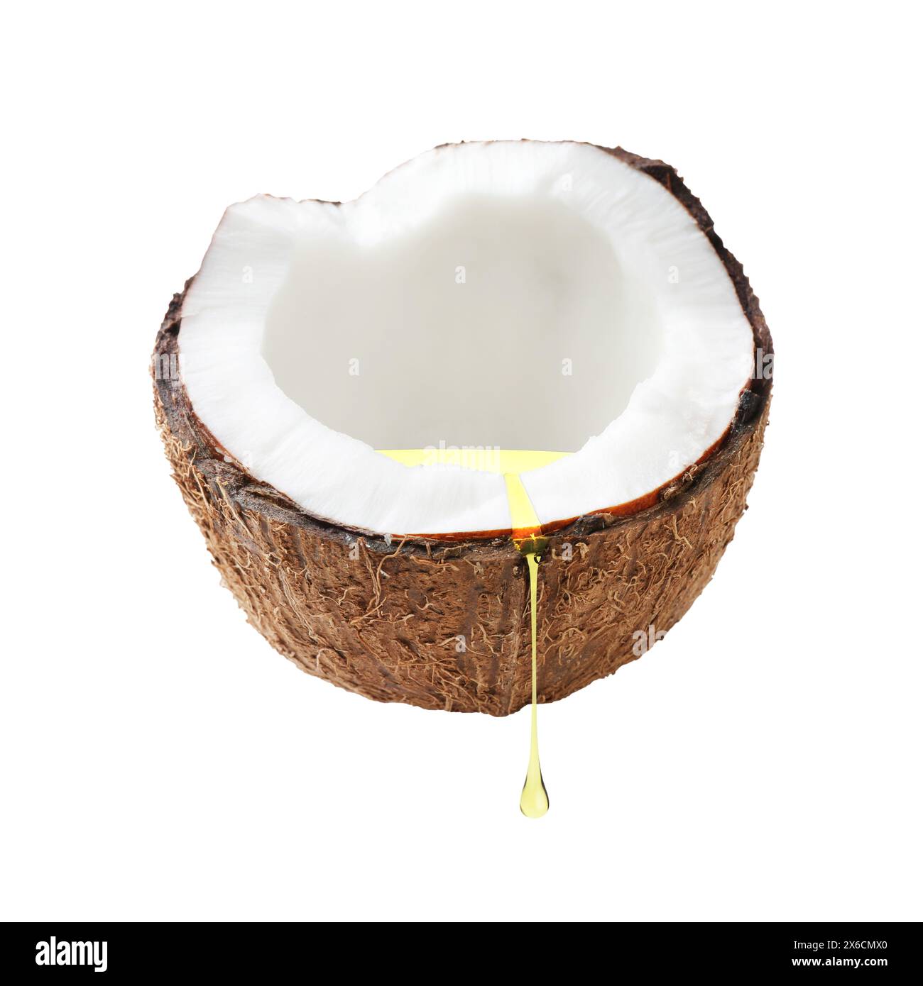 Coconut with dripping oil isolated on white Stock Photo - Alamy