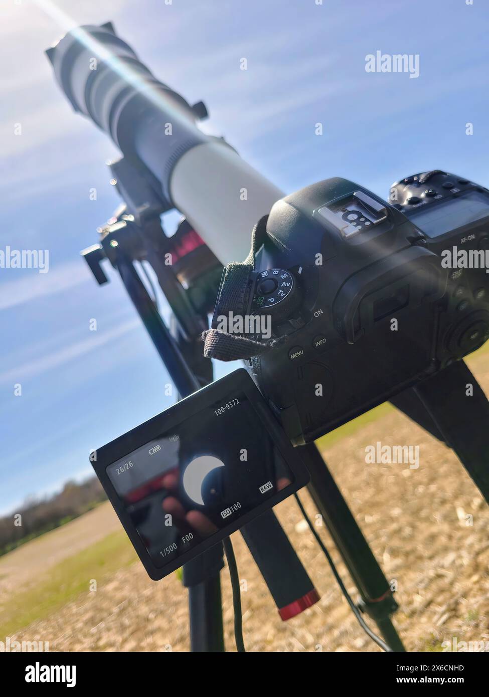 Eclipse Camera with Telephoto Lens on Tripod, Screen Showing Sun and ...