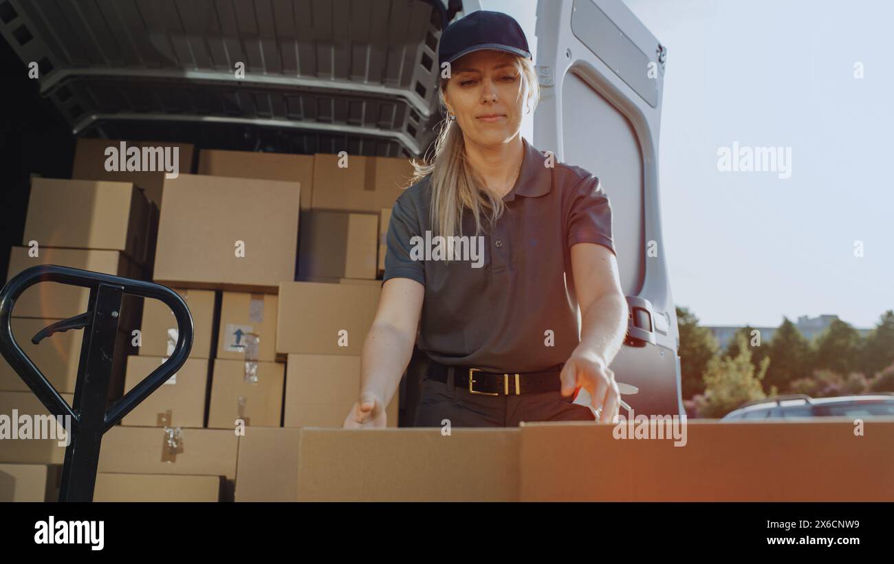 Logistics Warehouse: Female Worker Loading Delivery Truck with ...