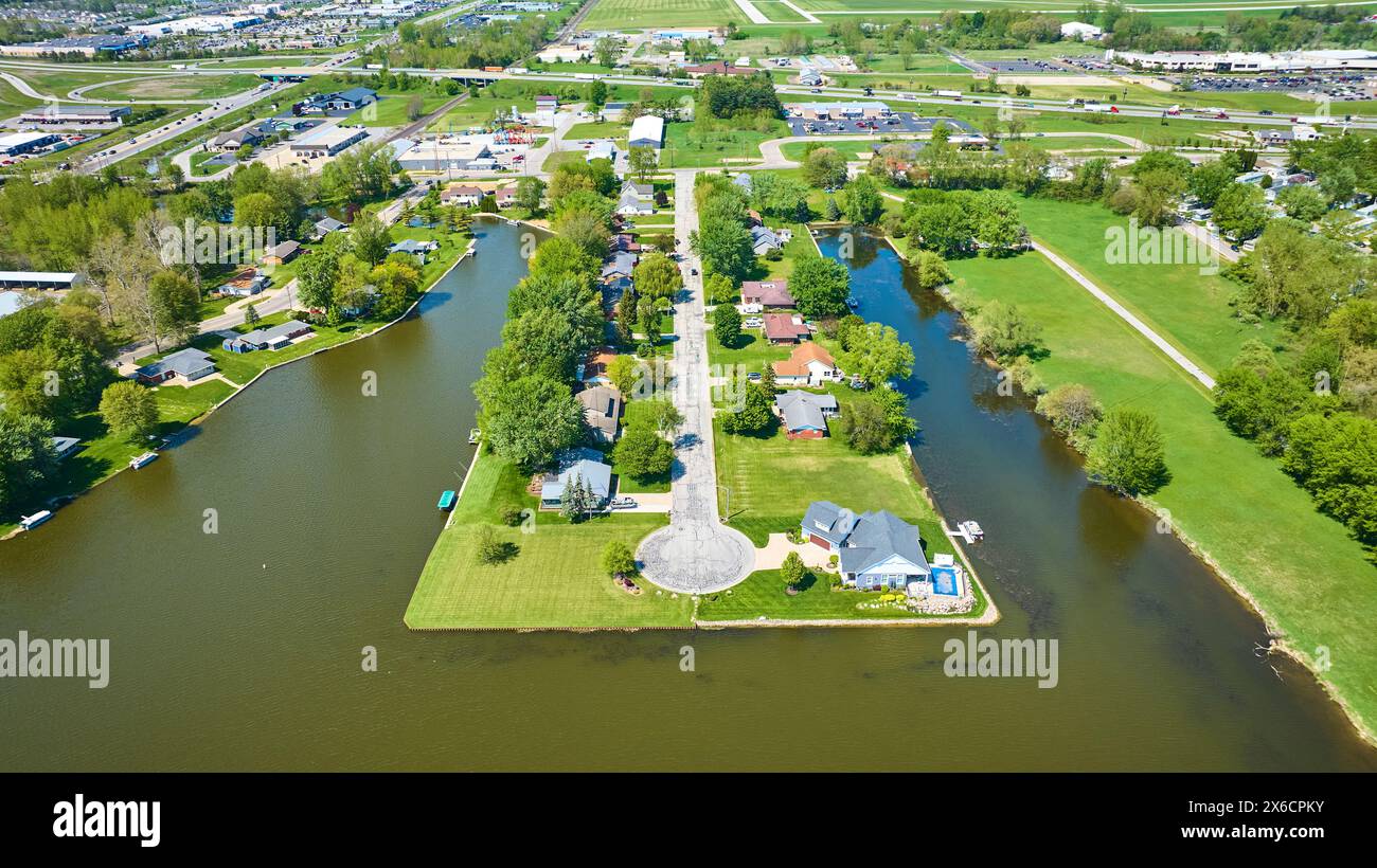 Aerial View of Suburban Homes by Serene Waterway with Community Park ...