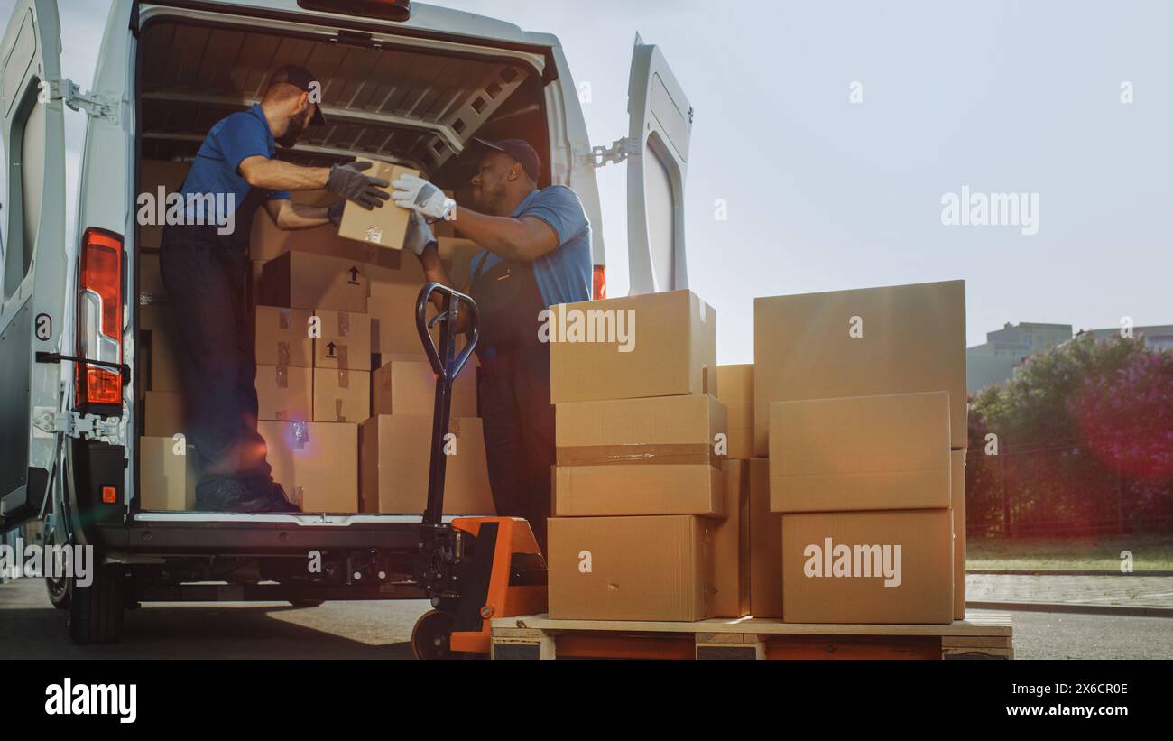 Logistics Warehouse Two Happy Friendly Laughing Workers use Hand Pallet ...