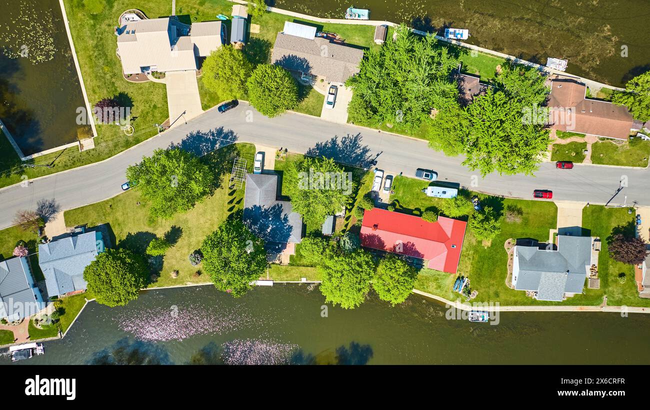 Aerial View of Suburban Neighborhood with Serene Lake and Lush Greenery ...