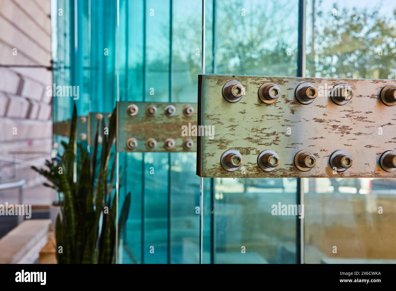 Aged Metal Beams and Bolts with Modern Glass Facade, Eye-Level Detail ...