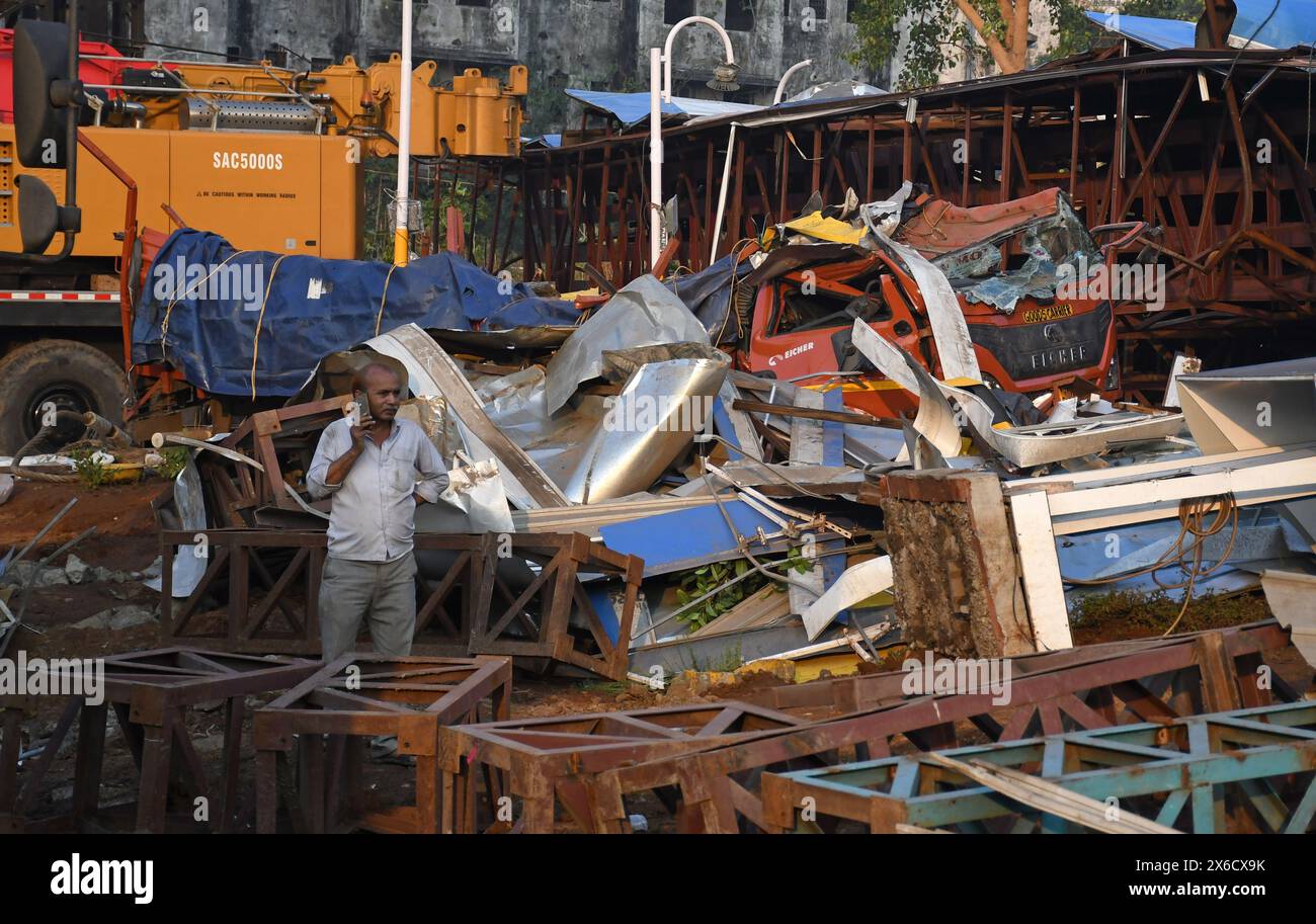 A man talks on a phone at a petrol pump where an advertising hoarding ...
